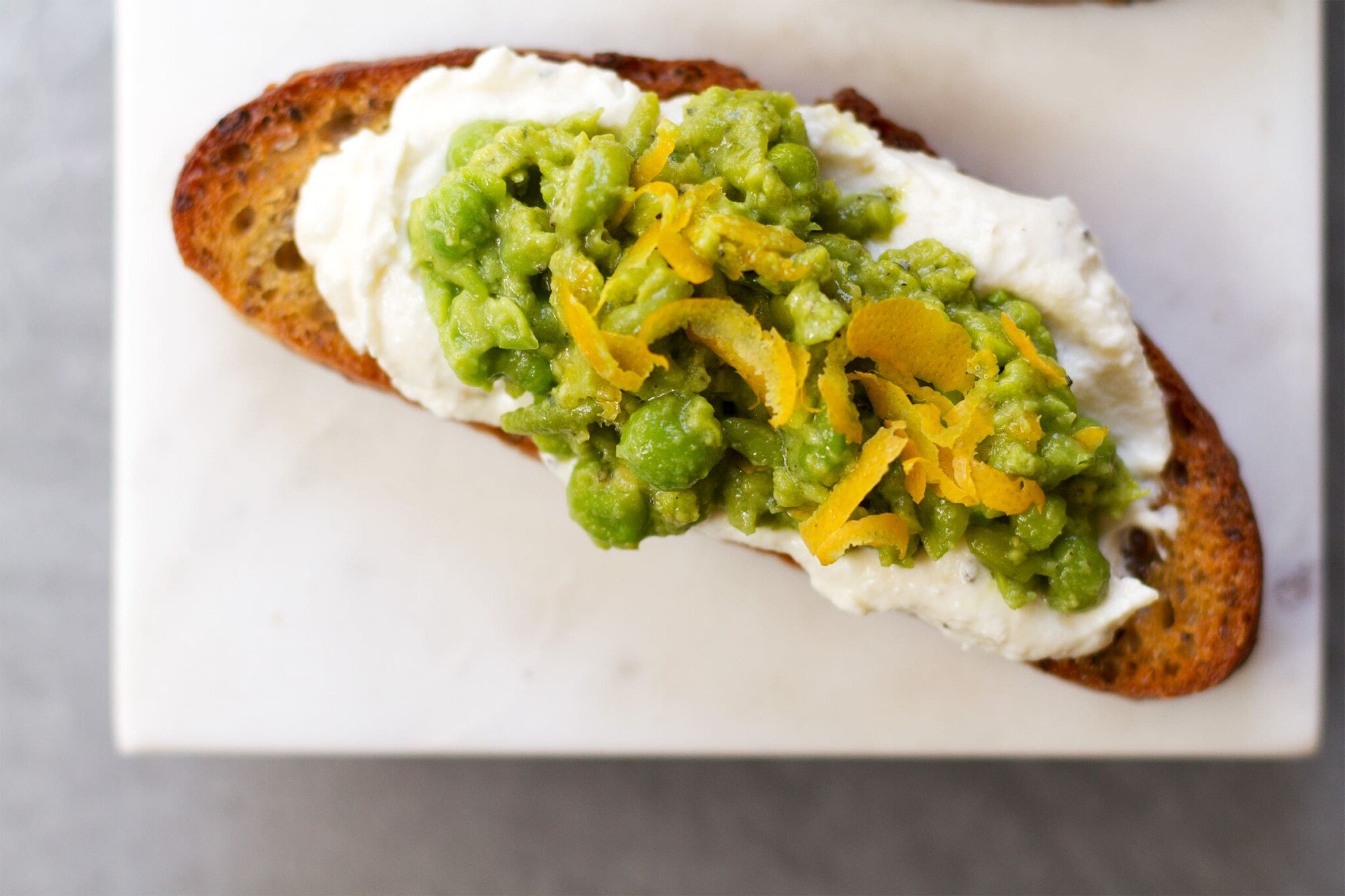 Whipped Ricotta Smashed Pea Crostini Recipe — Salt & Wind Travel